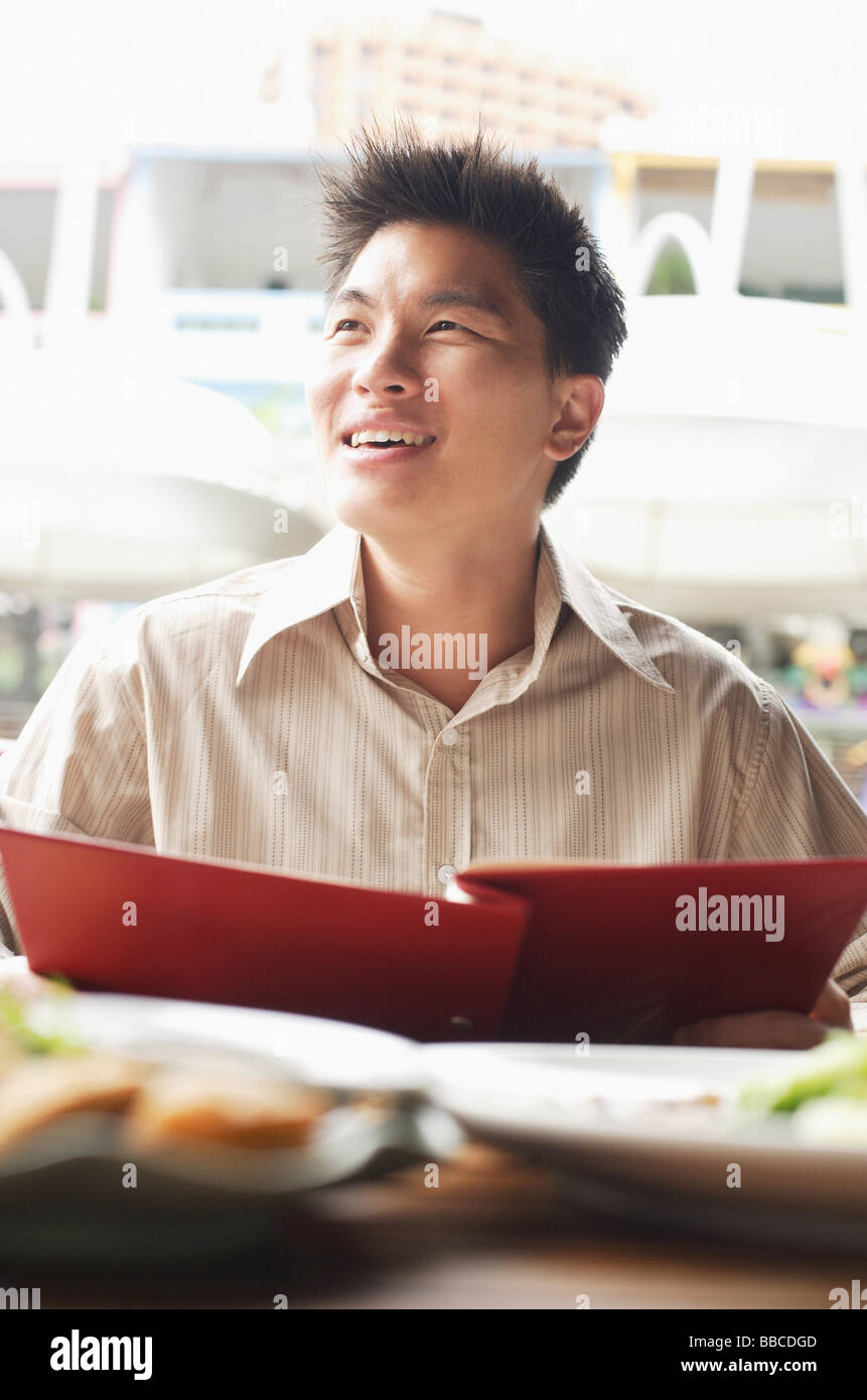 Man holding menu, away Stock Photo - Alamy