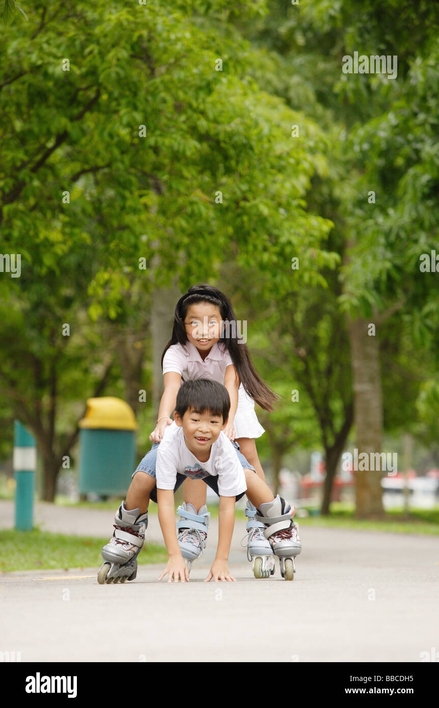 Children rollerblading, boy falling down Stock Photo - Alamy