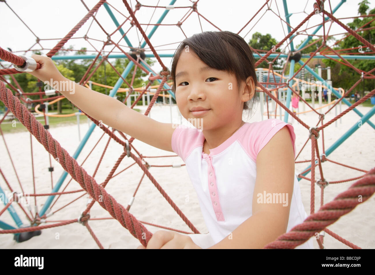Girl on jungle gym hi-res stock photography and images - Alamy