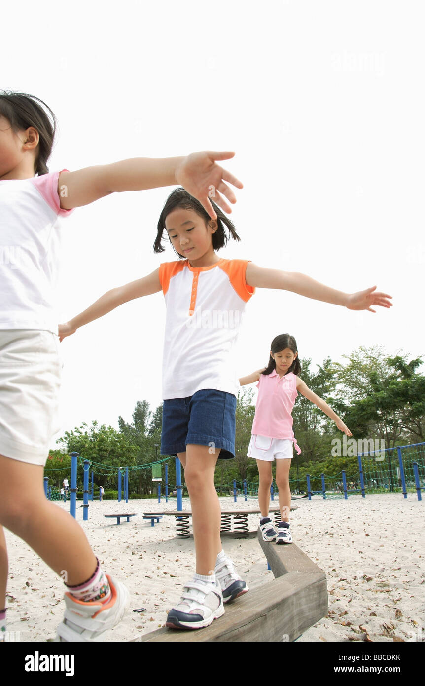 Girls walking on balance beams, arms outstretched Stock Photo - Alamy