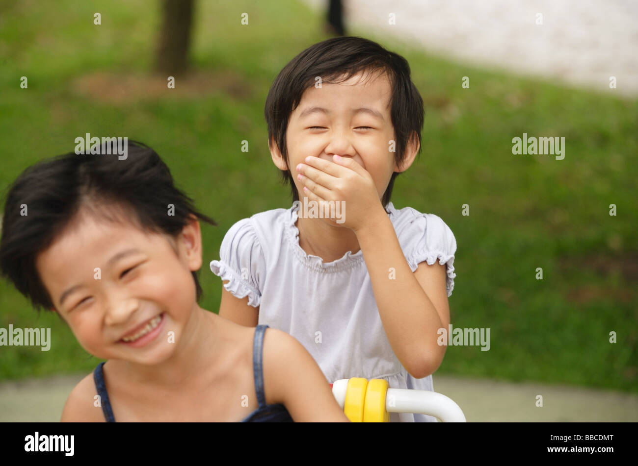 Young girls in playground, laughing Stock Photo - Alamy