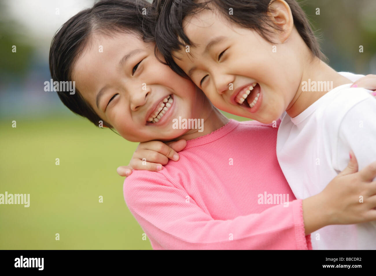 Two girls with arms around each other hi-res stock photography and ...