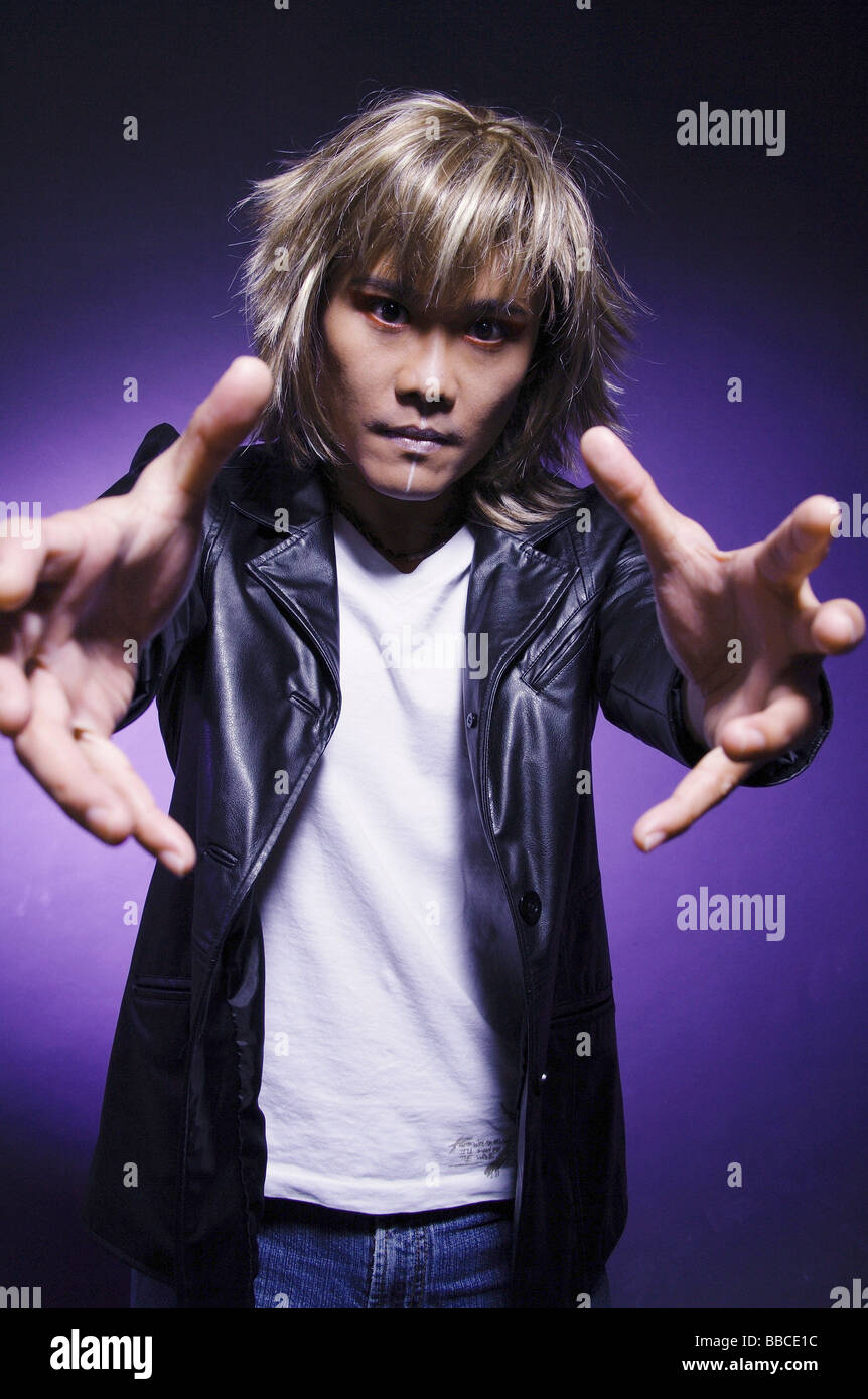 Man in leather jacket and face paint, hands reaching forward Stock ...
