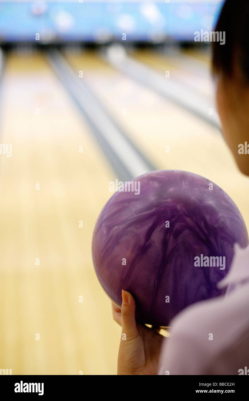 Woman holding bowling ball, over the shoulder view Stock Photo - Alamy