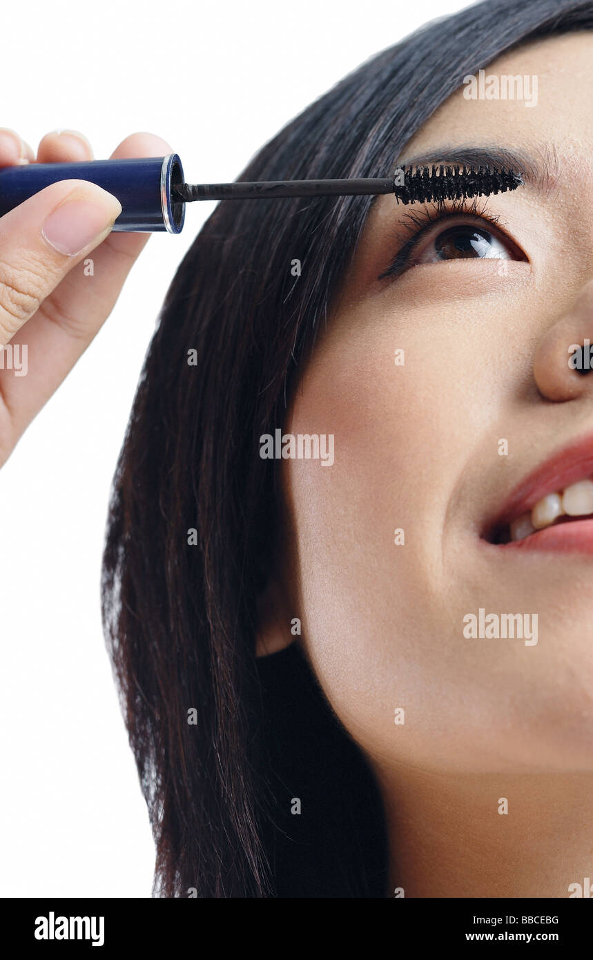 Woman applying mascara Stock Photo - Alamy