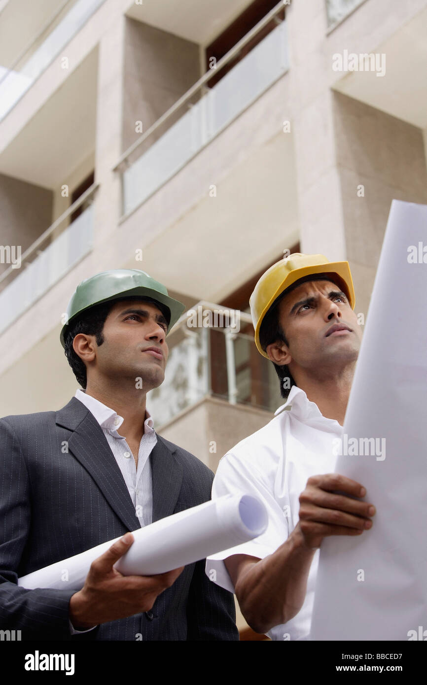 contractors or architects with blueprints Stock Photo - Alamy