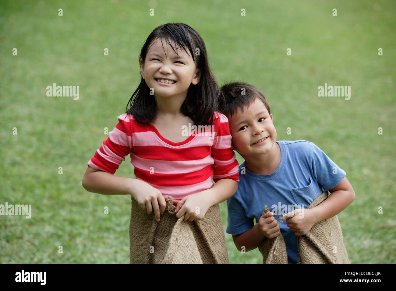 Kids ready for a sack race Stock Photo - Alamy