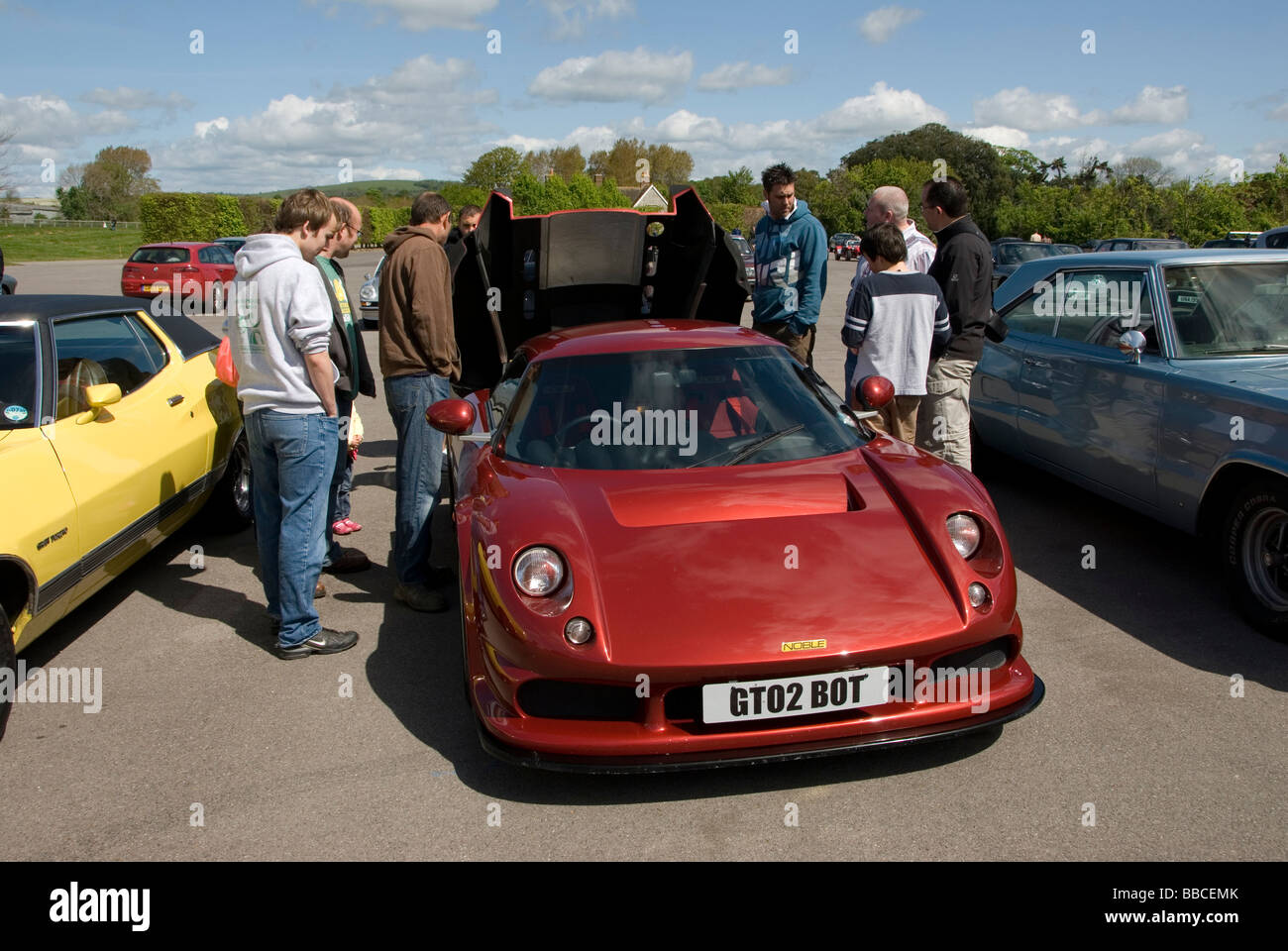 Noble enthusiasts check out the engine on a Noble M12 at the Goodwood ...