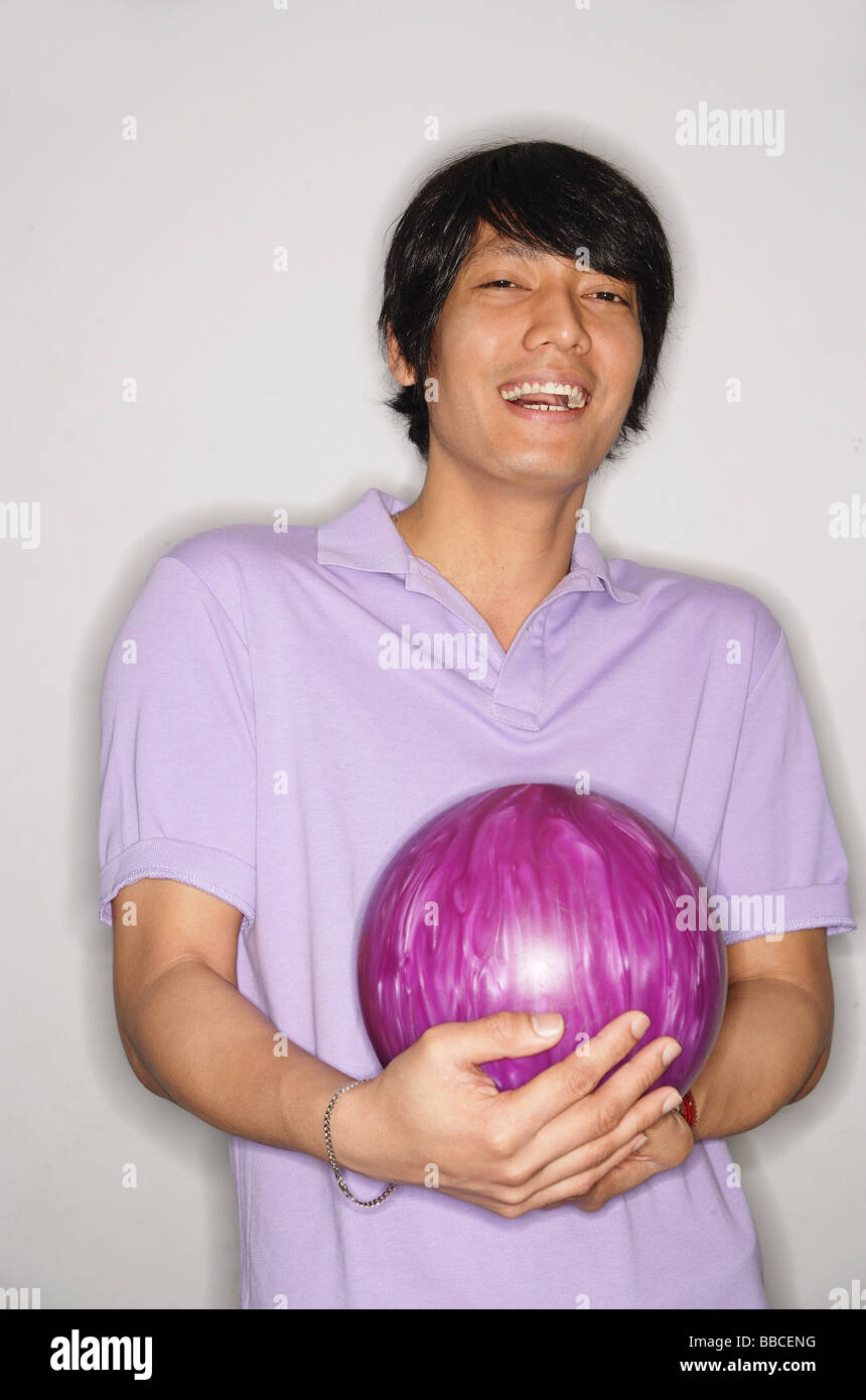 Man carrying bowling ball, looking at camera Stock Photo - Alamy