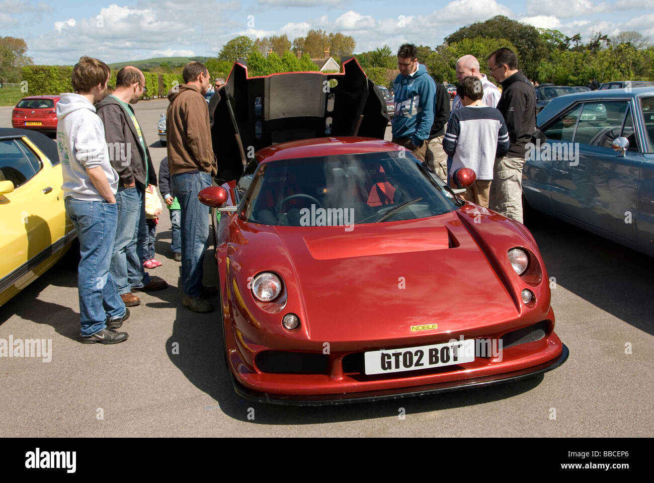 Noble enthusiasts check out the engine on a Noble M12 at the Goodwood ...