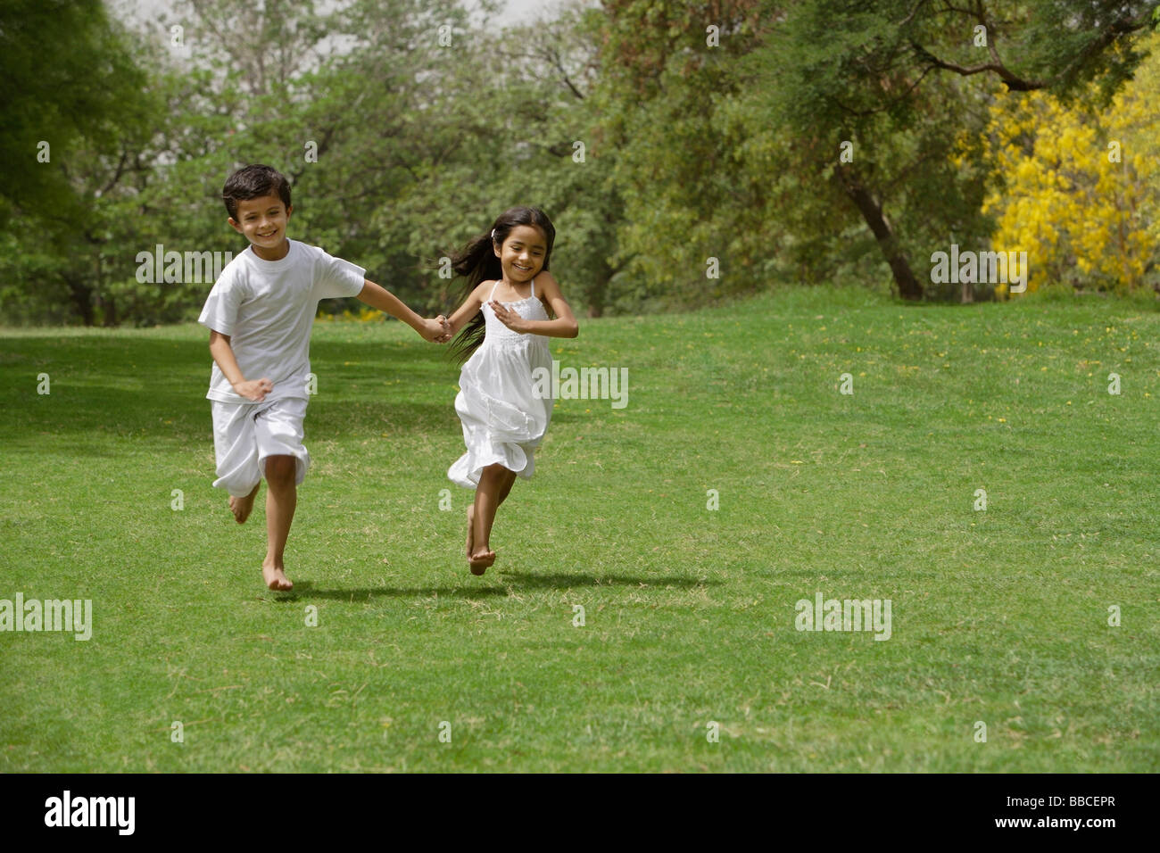 kids running in park, holding hands Stock Photo - Alamy