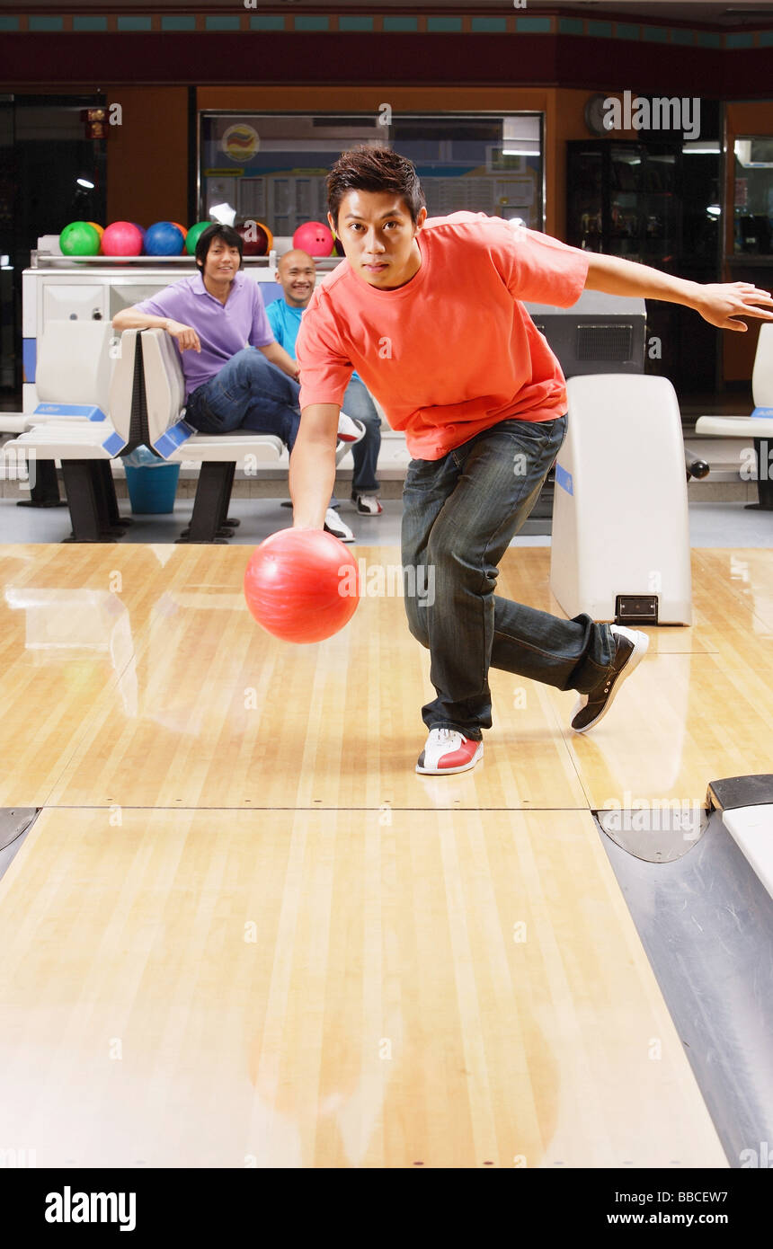 Man bowling, people watching in the background Stock Photo - Alamy