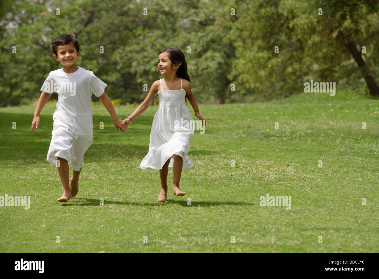 kids running in park, holding hands Stock Photo - Alamy