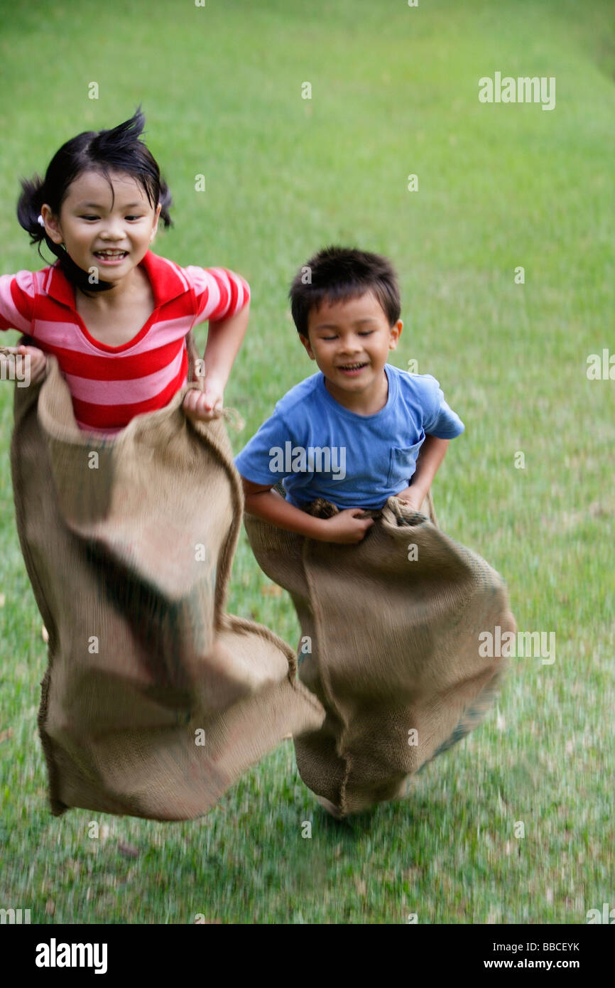 Kids having sack race Stock Photo - Alamy