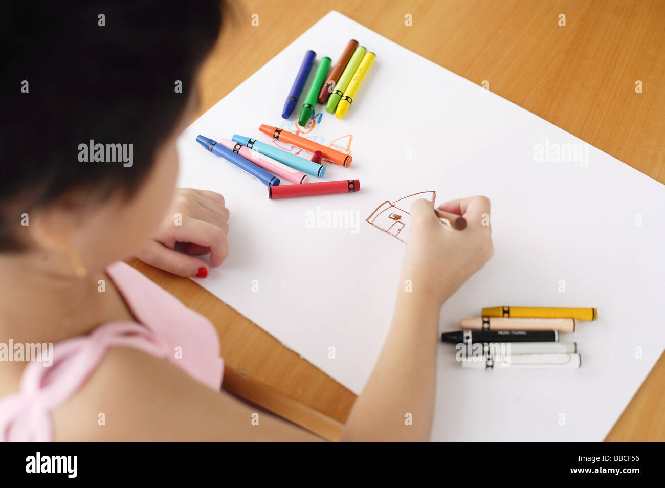 Girl drawing on paper, over the shoulder view Stock Photo - Alamy