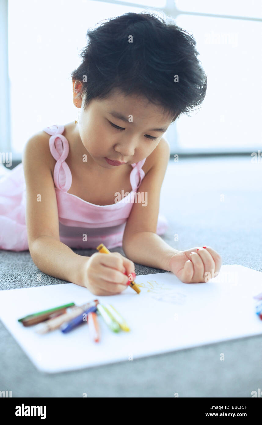 Young girl lying on floor, drawing Stock Photo - Alamy