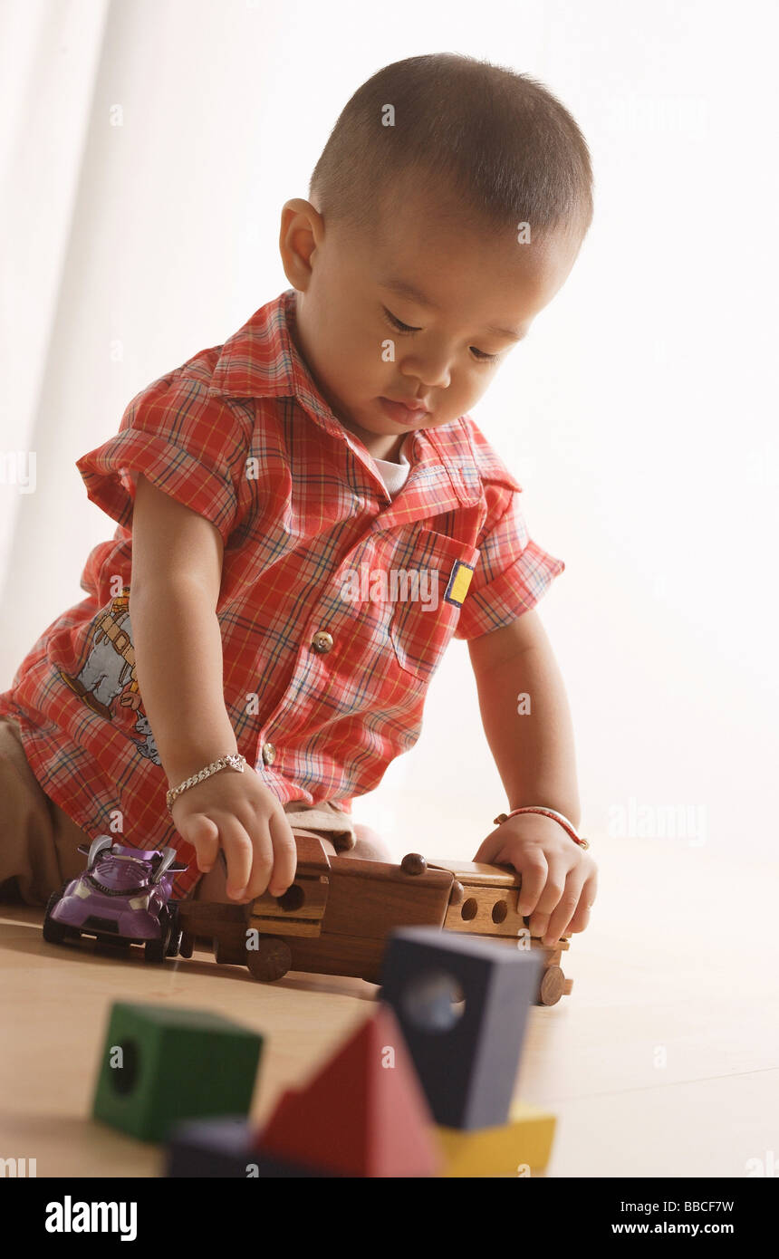 Young boy playing with toy train Stock Photo - Alamy