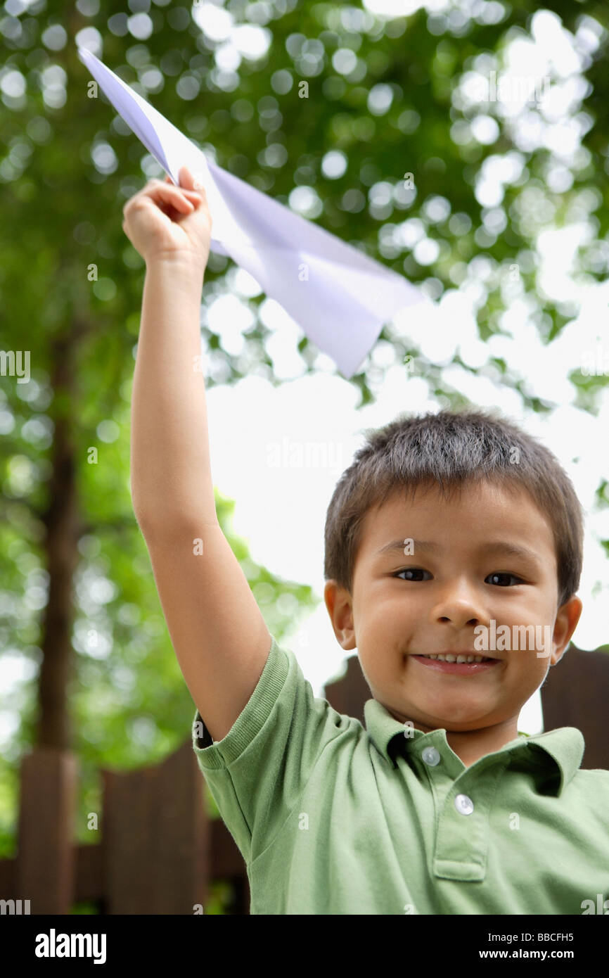 Boy with paper airplane Stock Photo - Alamy