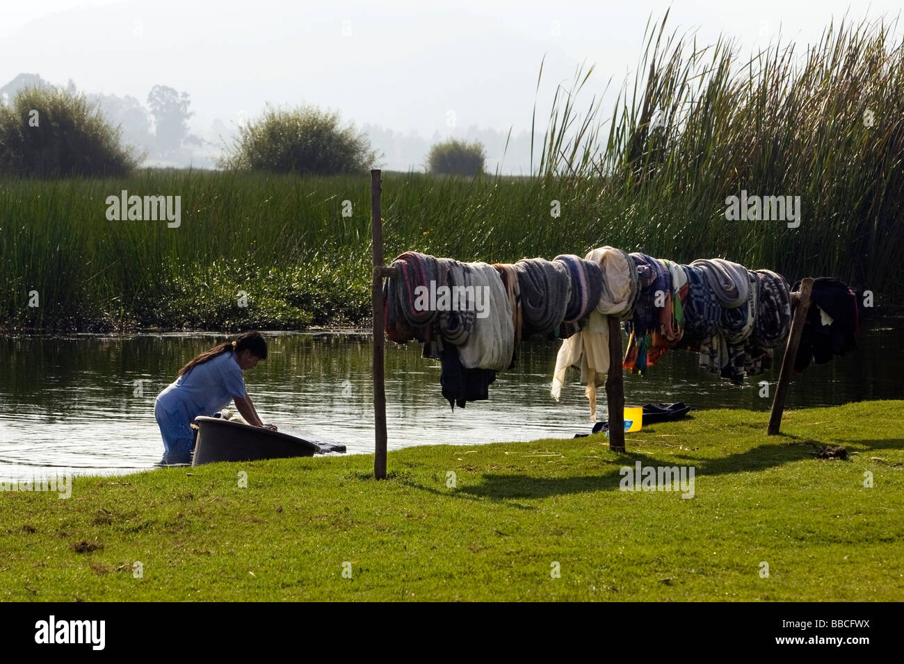 Indian woman washing clothes by hand hi-res stock photography and ...