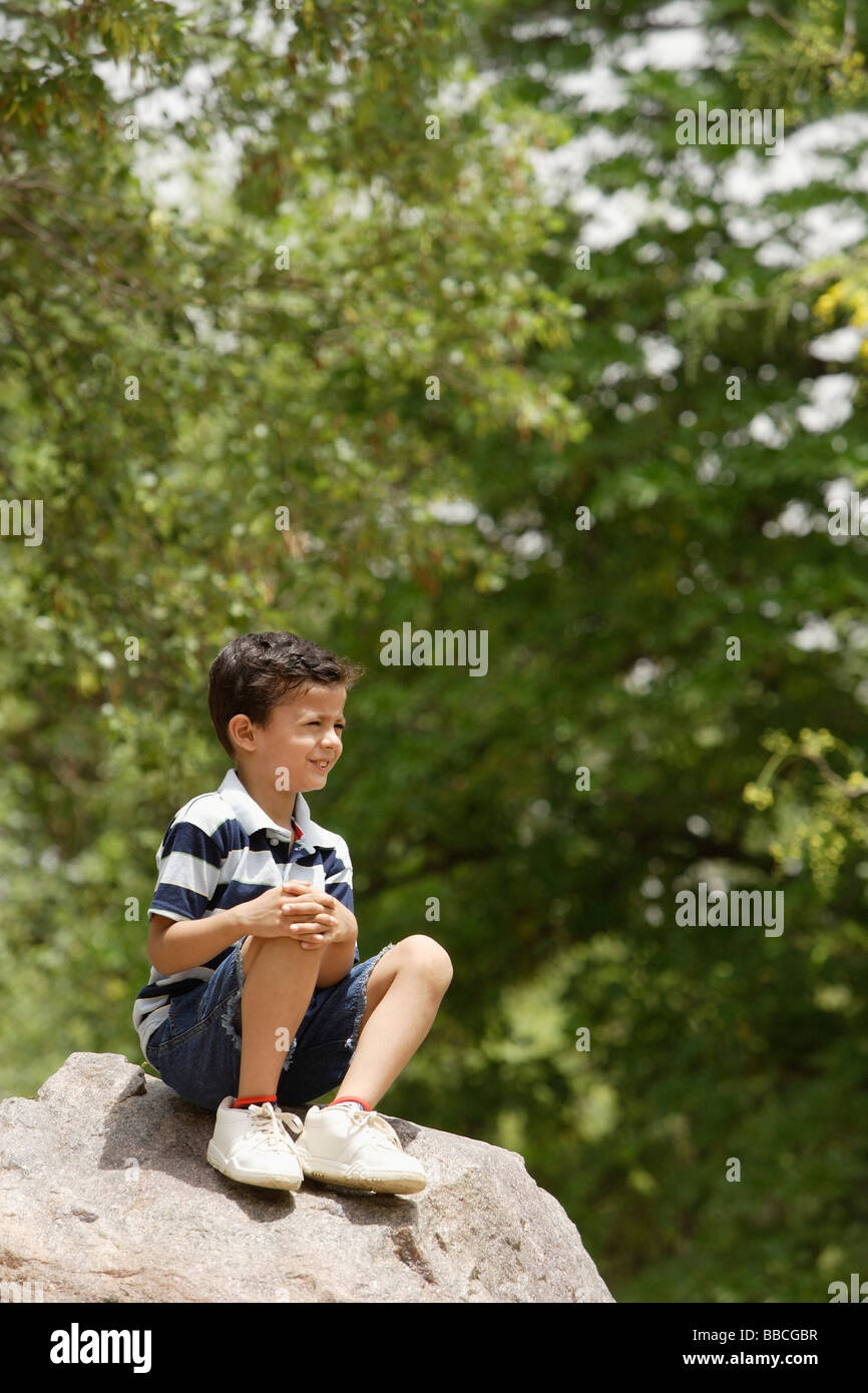 boy sitting on rocks Stock Photo - Alamy