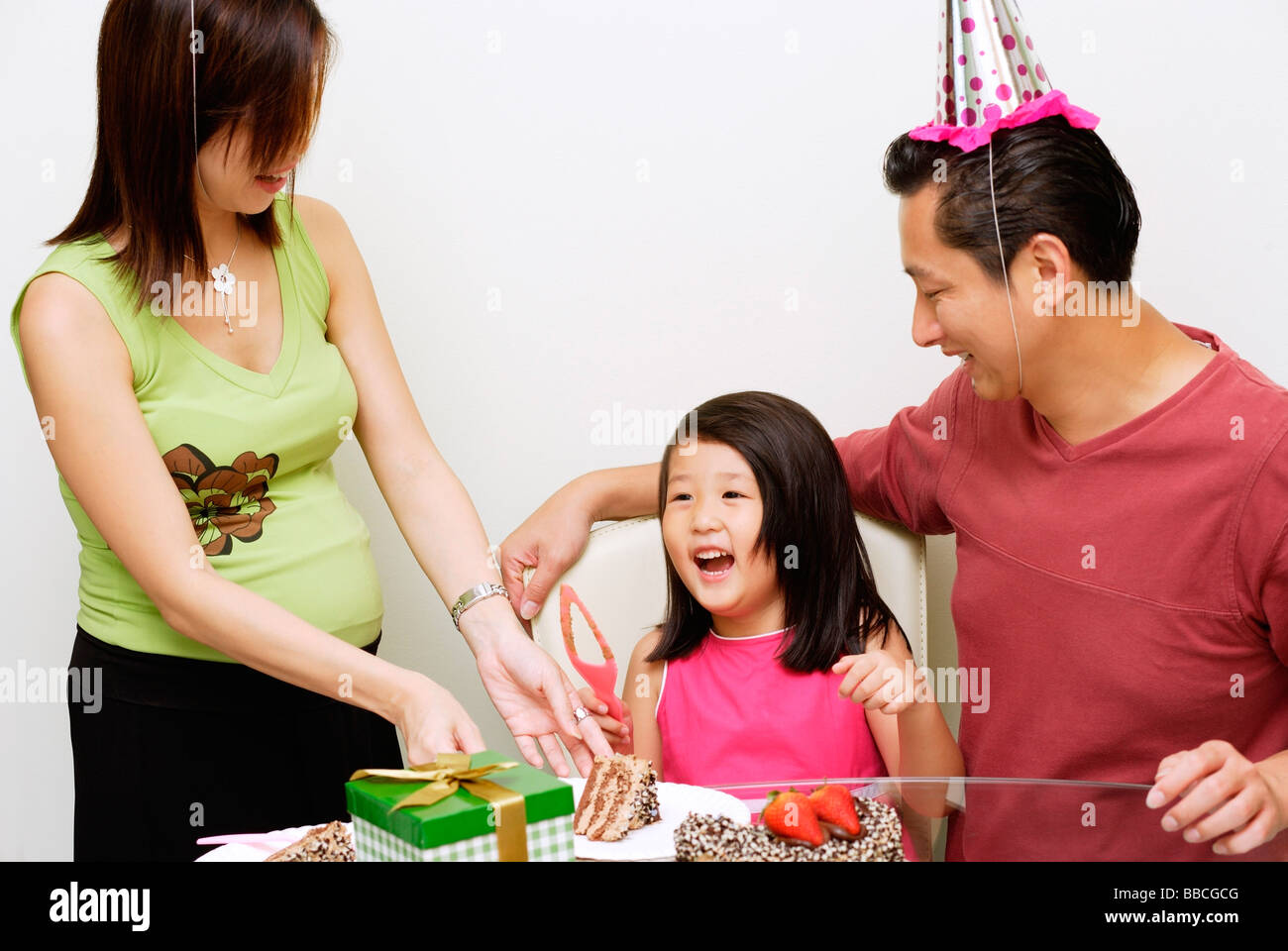 Family with one child celebrating a birthday Stock Photo - Alamy