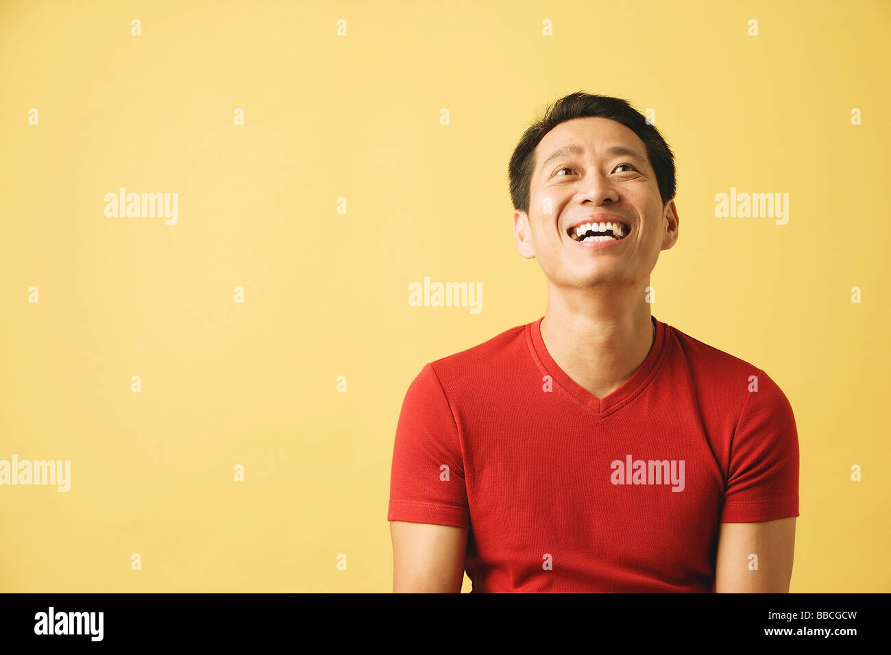 Man smiling, looking up, portrait Stock Photo - Alamy