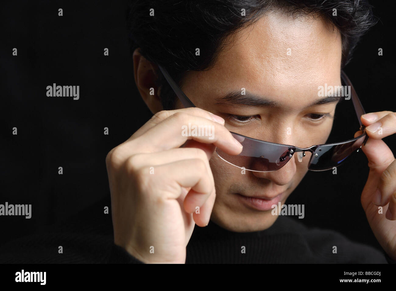 Man adjusting sunglasses hi-res stock photography and images - Alamy