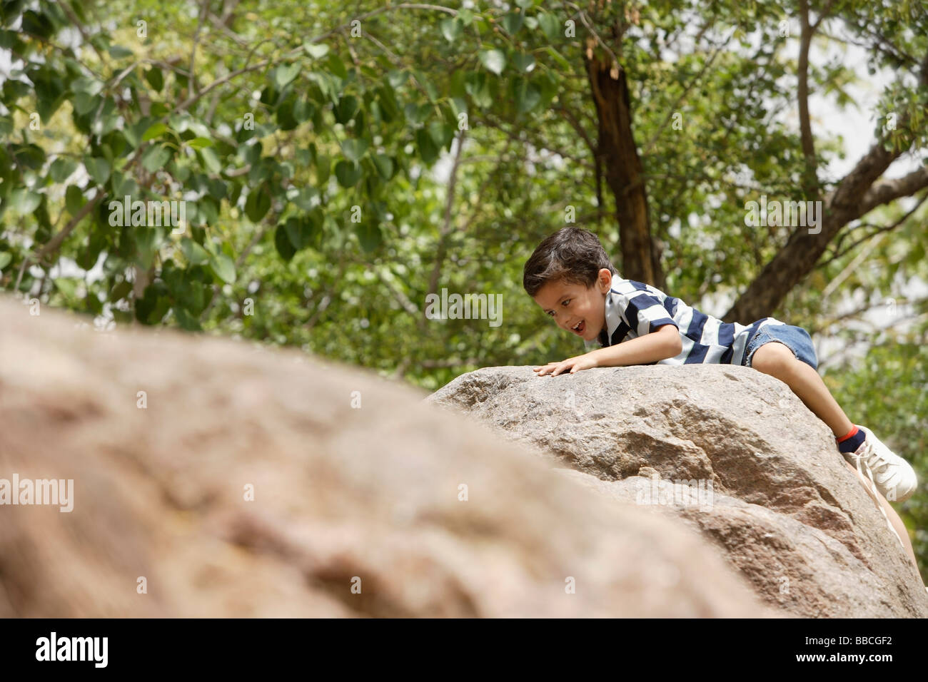 boy climbing on rocks Stock Photo - Alamy