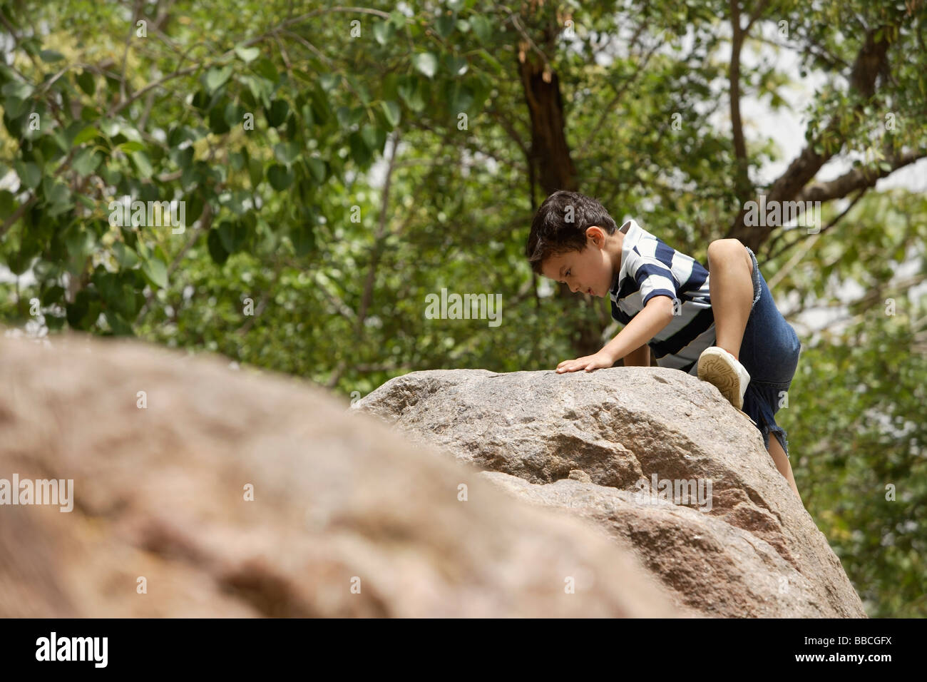 boy climbing on rocks Stock Photo - Alamy