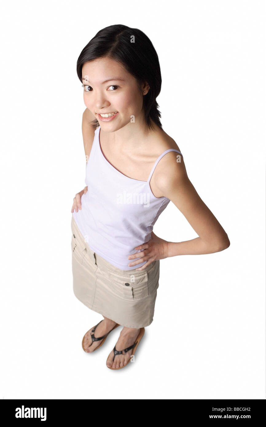 Young woman smiling at camera, hands on hips Stock Photo - Alamy