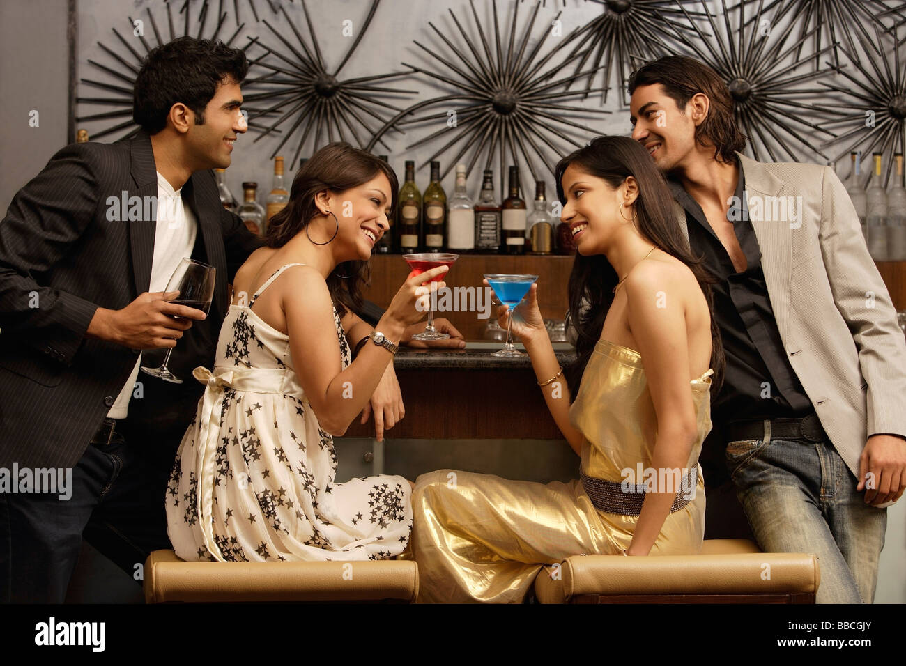 two couples in a bar Stock Photo - Alamy