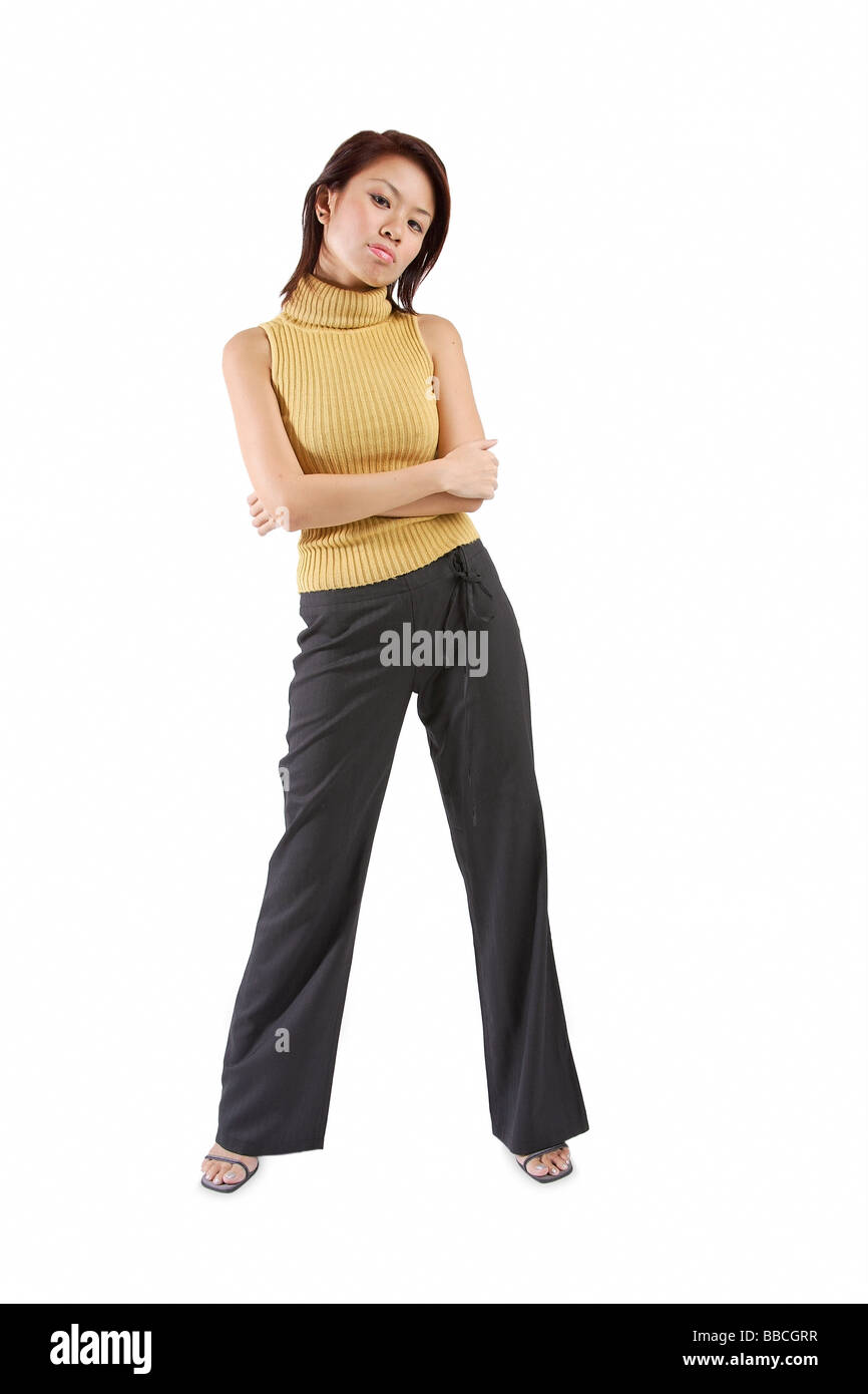 Young woman standing, arms crossed Stock Photo - Alamy
