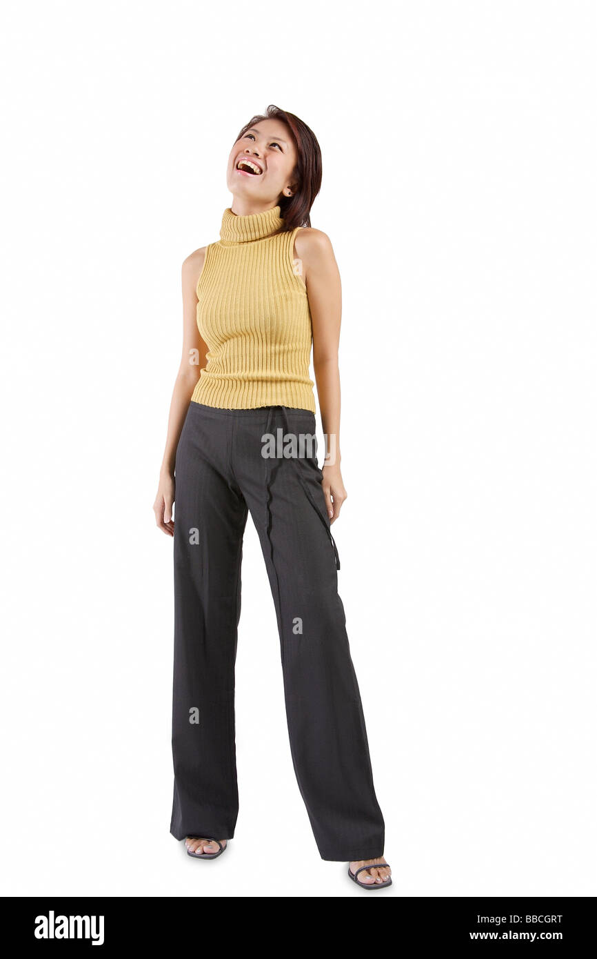 Young woman standing, looking up Stock Photo - Alamy