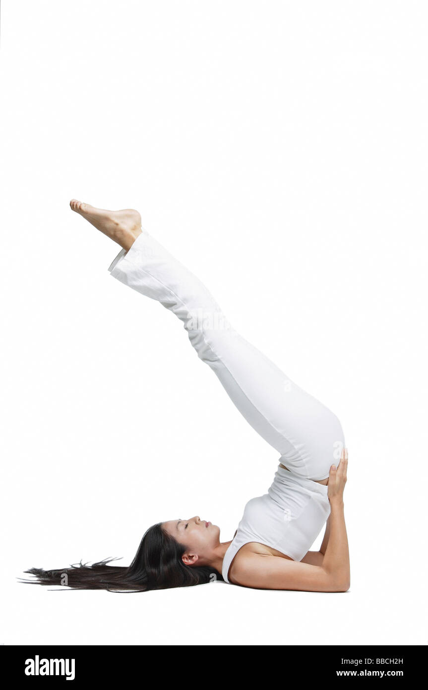 Woman doing yoga, shoulder stand position Stock Photo - Alamy