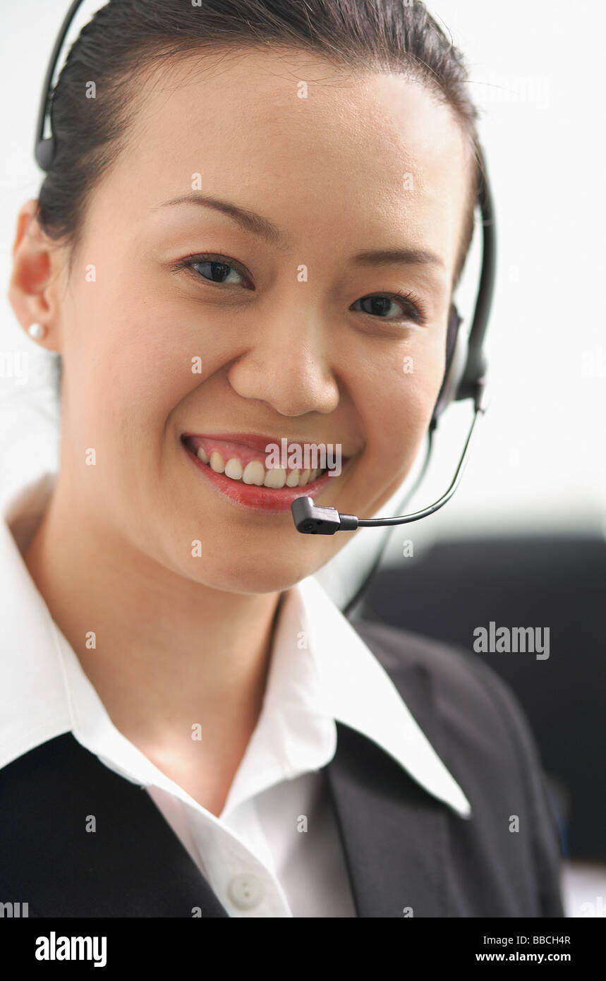 Woman with headset, looking at camera Stock Photo - Alamy