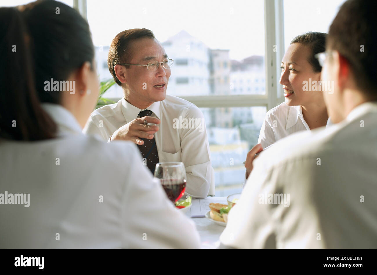 Asian business man talking over lunch hi-res stock photography and ...