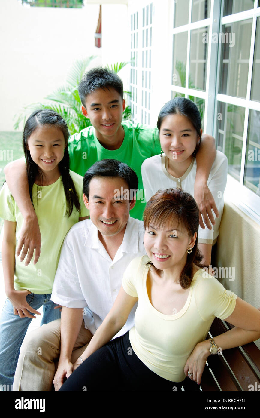Family looking at camera and smiling Stock Photo - Alamy