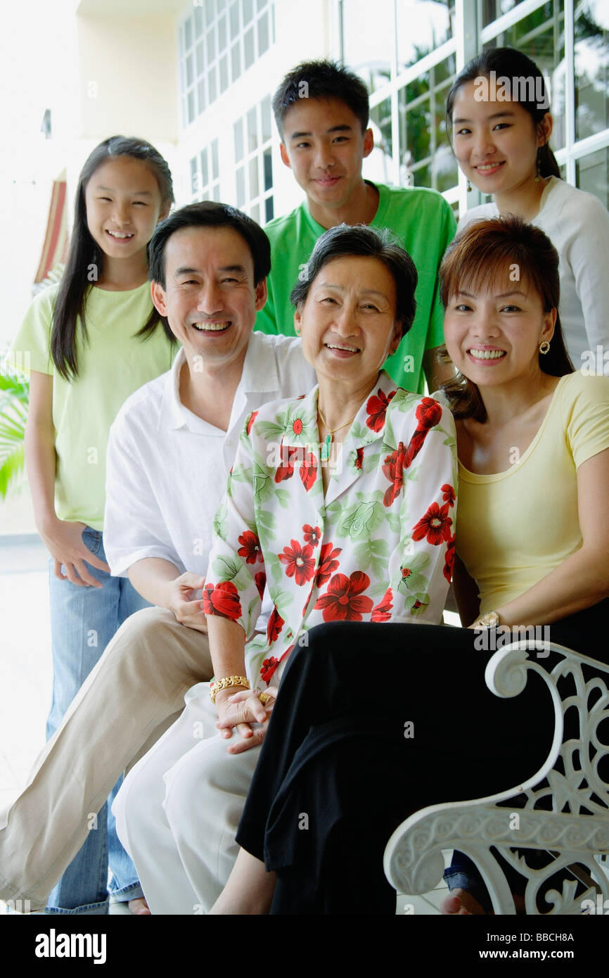 Three generation family smiling at camera Stock Photo - Alamy