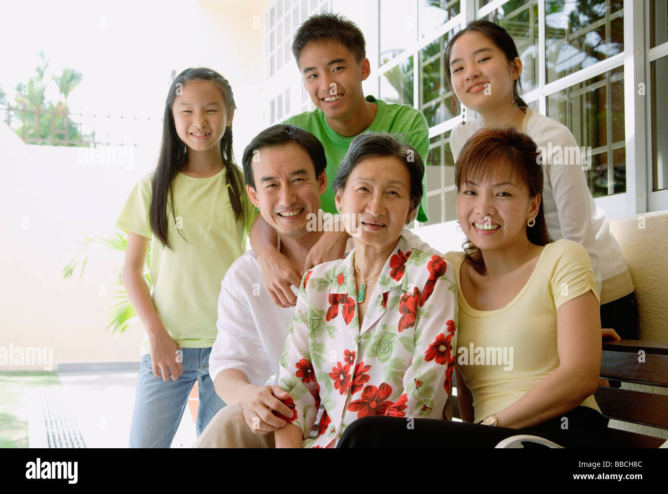 Three generation family on patio, looking at camera, smiling Stock ...