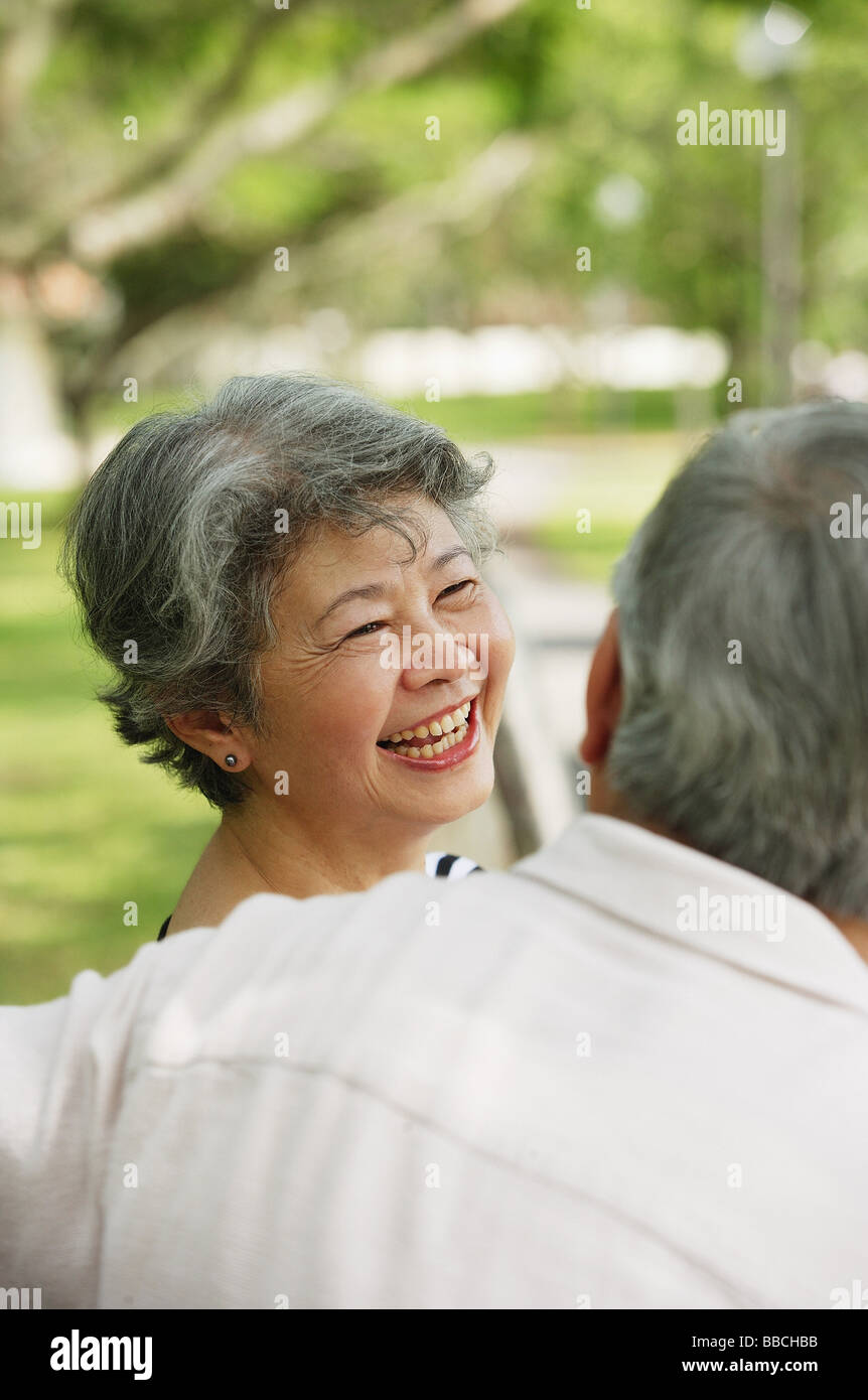 Woman smiling, over the shoulder view Stock Photo - Alamy