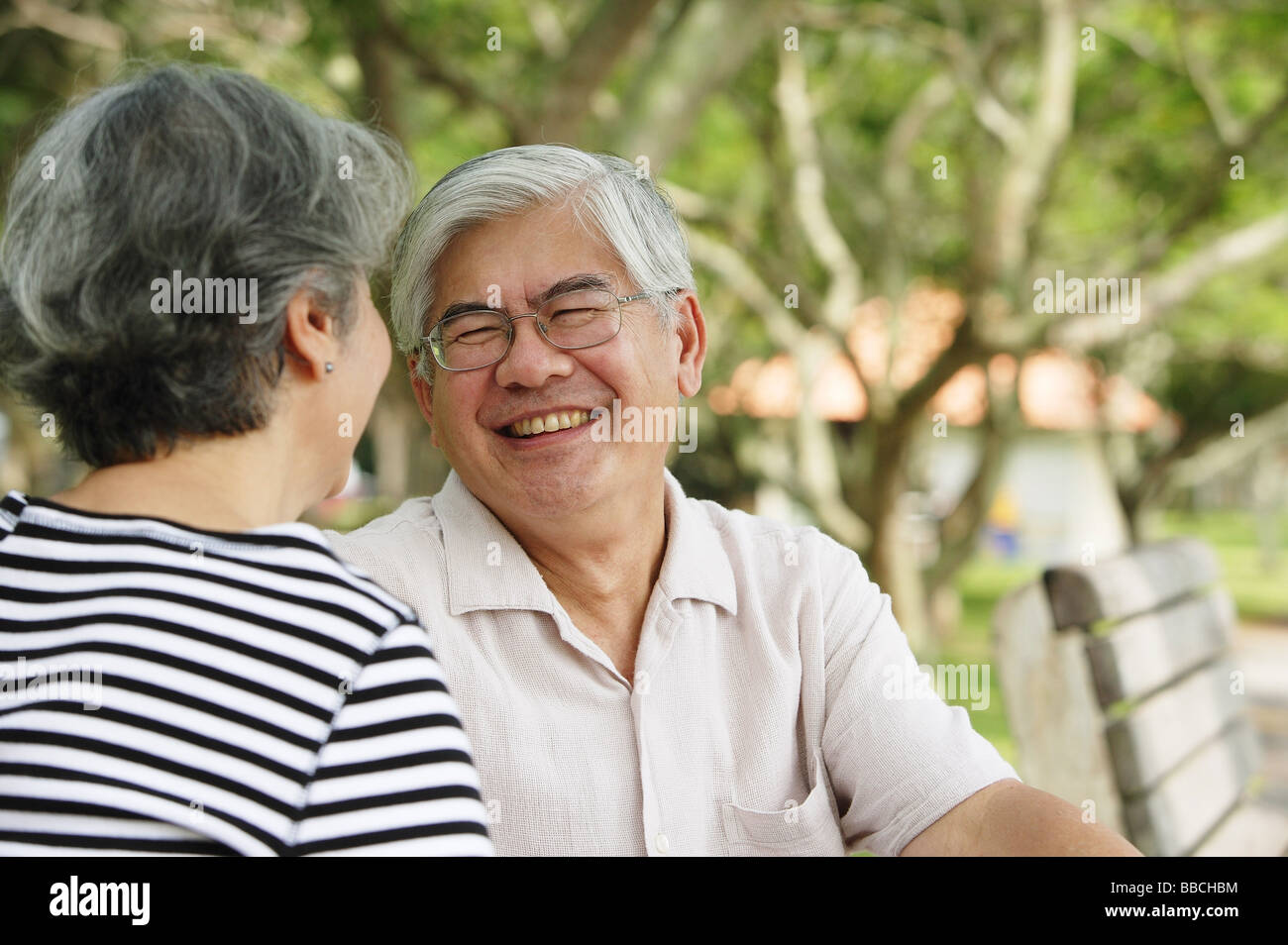 Mature couple facing each other, man smiling Stock Photo - Alamy