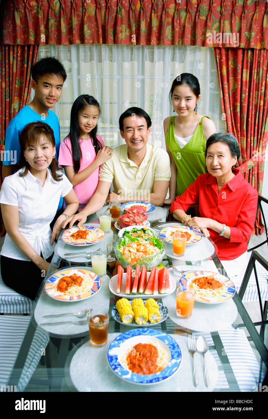 Three generation family around dining table hi-res stock photography ...