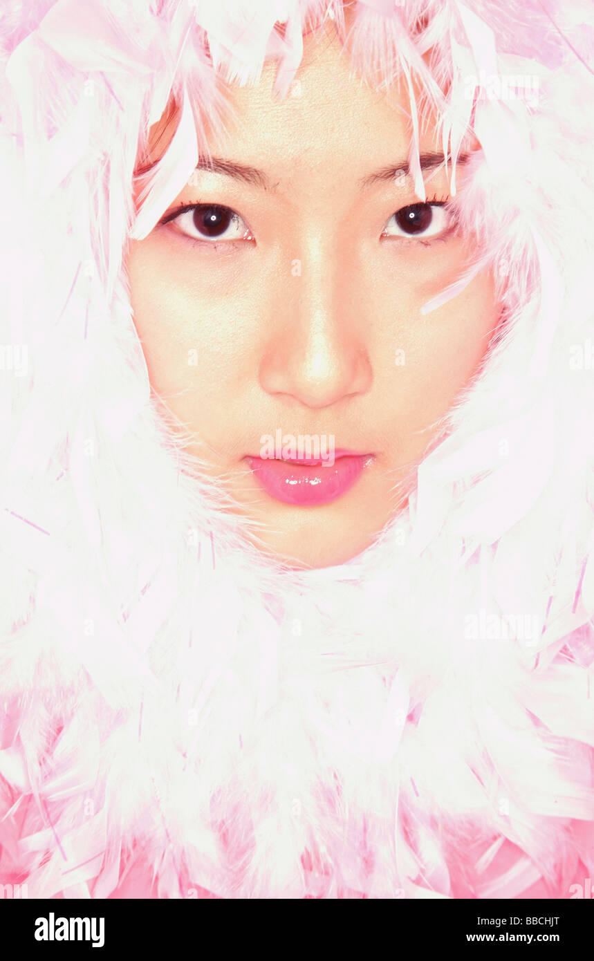 Womans face surrounded by feathers Stock Photo - Alamy
