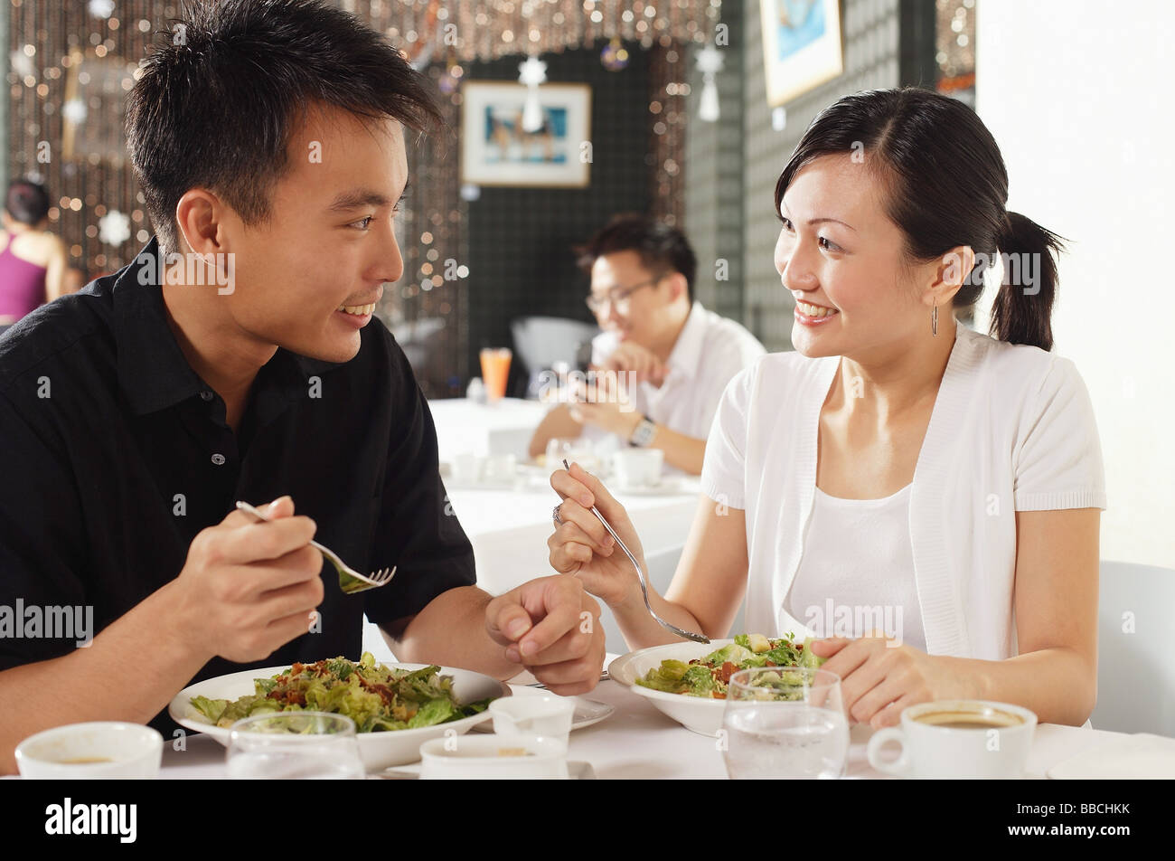 Couple eating at restaurant Stock Photo - Alamy