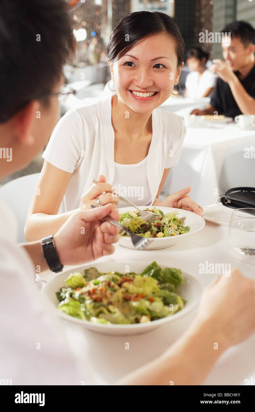 Couple eating at restaurant, over the shoulder view Stock Photo - Alamy