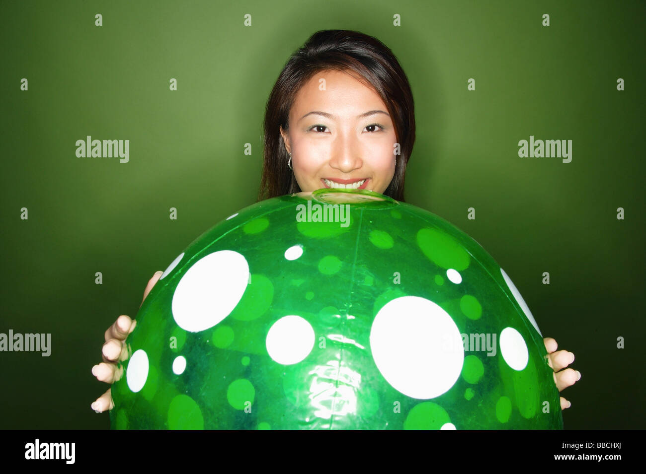 Woman holding big green inflated ball Stock Photo - Alamy