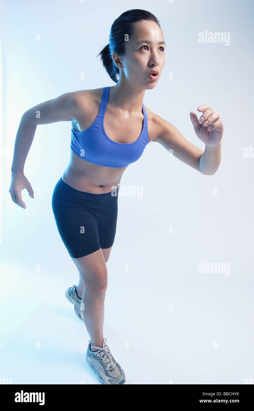 Woman in running position Stock Photo - Alamy