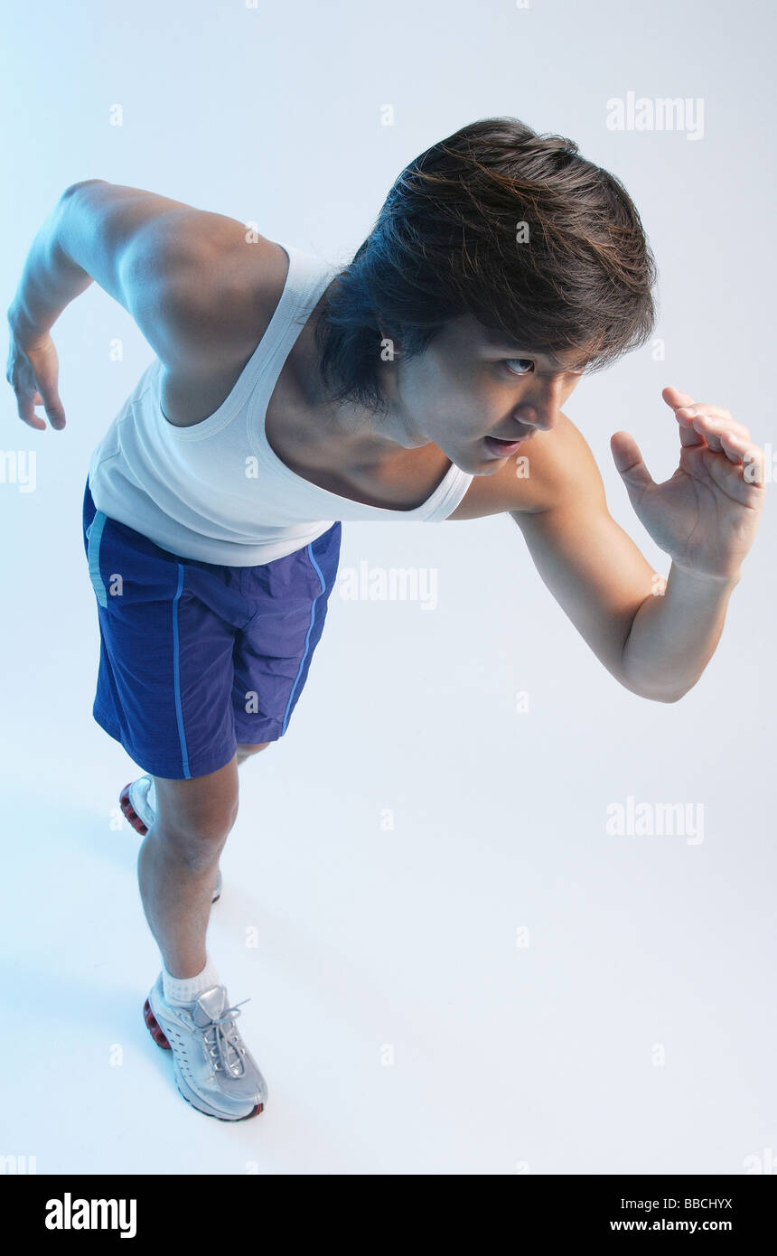 Man in running position, high angle view Stock Photo - Alamy