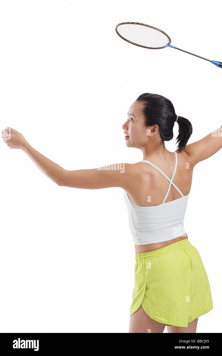 Woman holding badminton racket, about to serve Stock Photo - Alamy