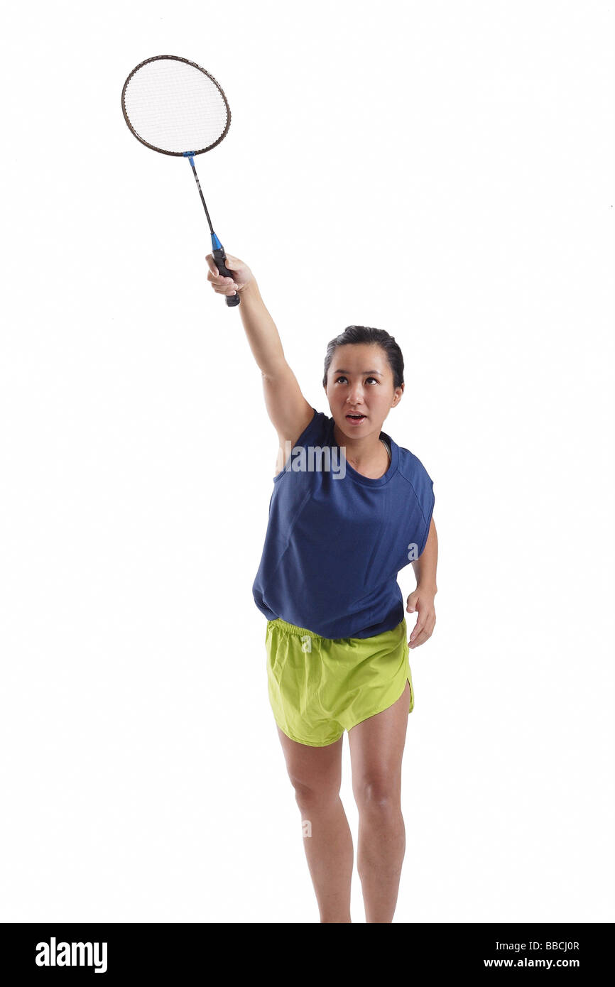 Woman holding badminton racket up Stock Photo - Alamy